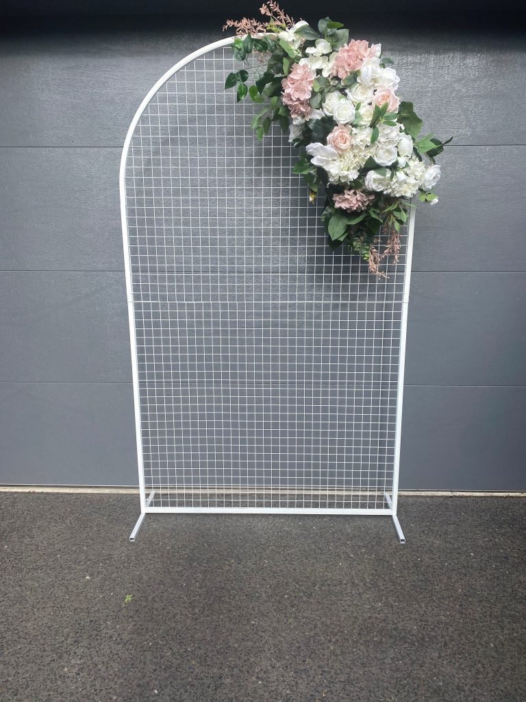 WHITE MESH ARCH BACKDROP WITH FAUX FLORALS | Styled Event Hire