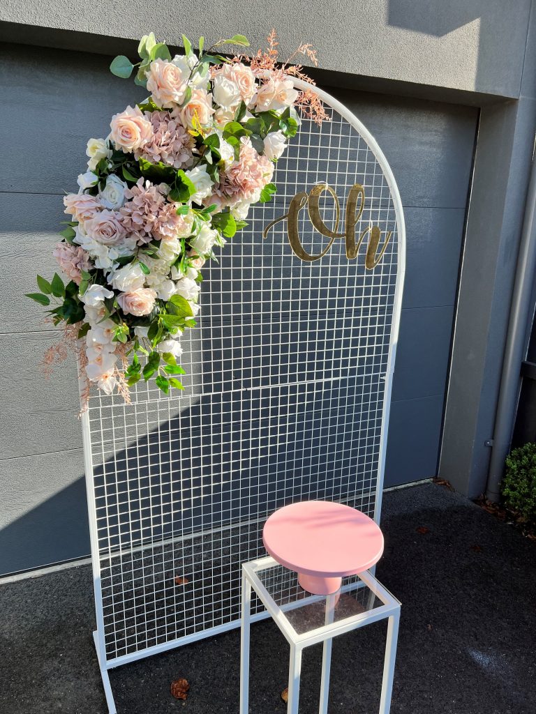 WHITE MESH ARCH BACKDROP WITH FAUX FLORALS | Styled Event Hire